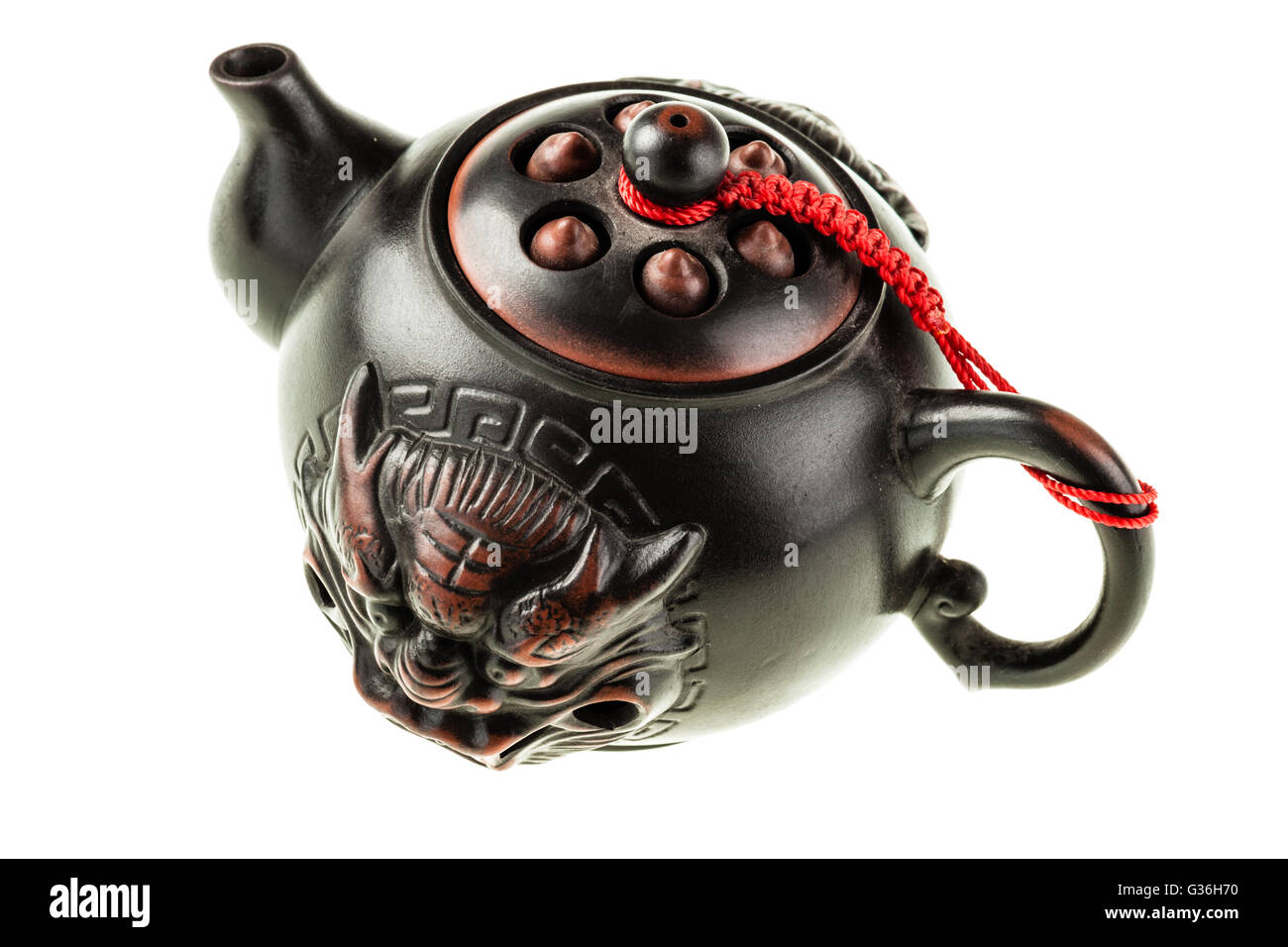 a decorated dark japanese teapot isolated over a white background Stock ...