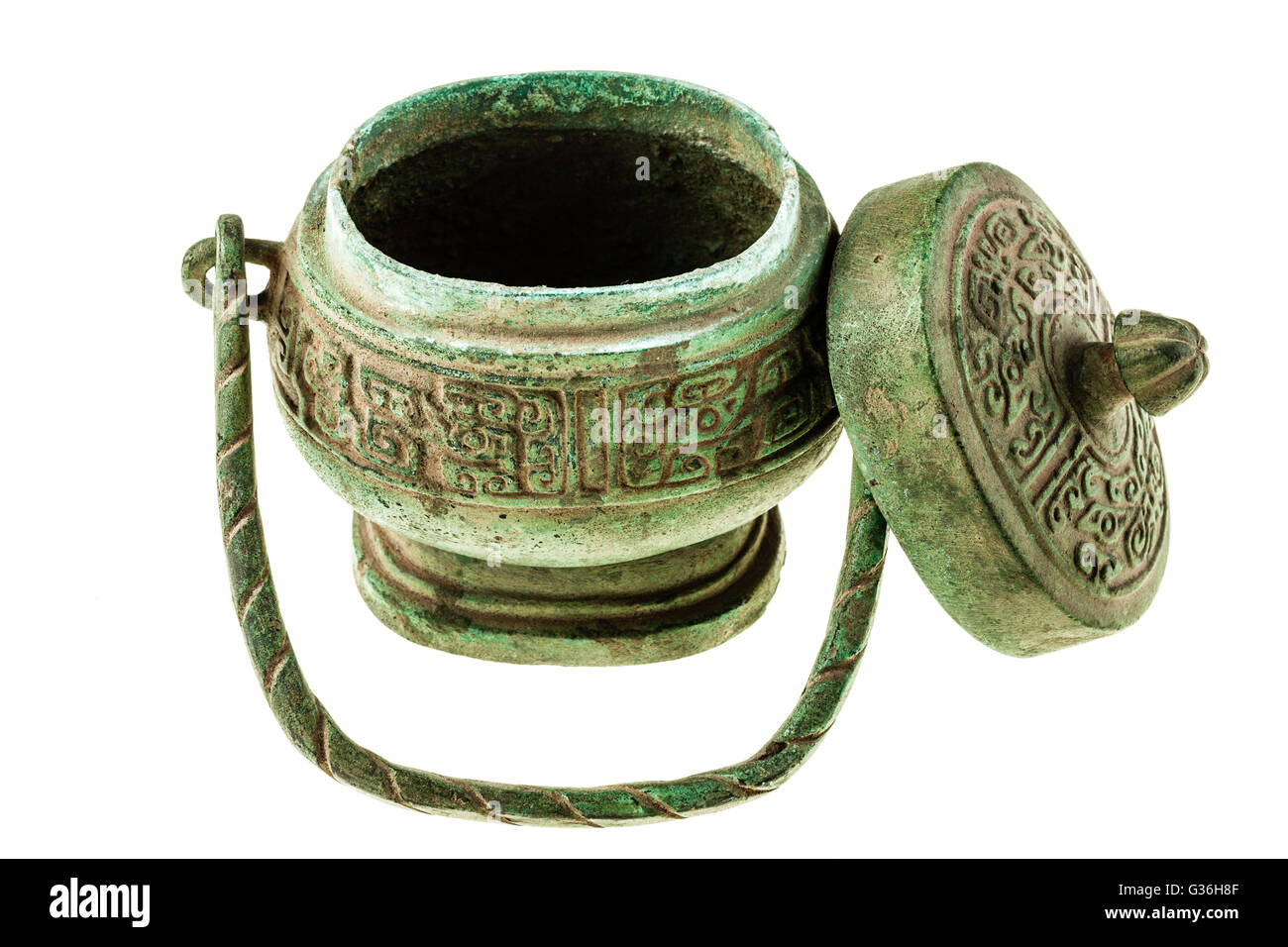 a corroded ancient chinese container isolated over a white background ...