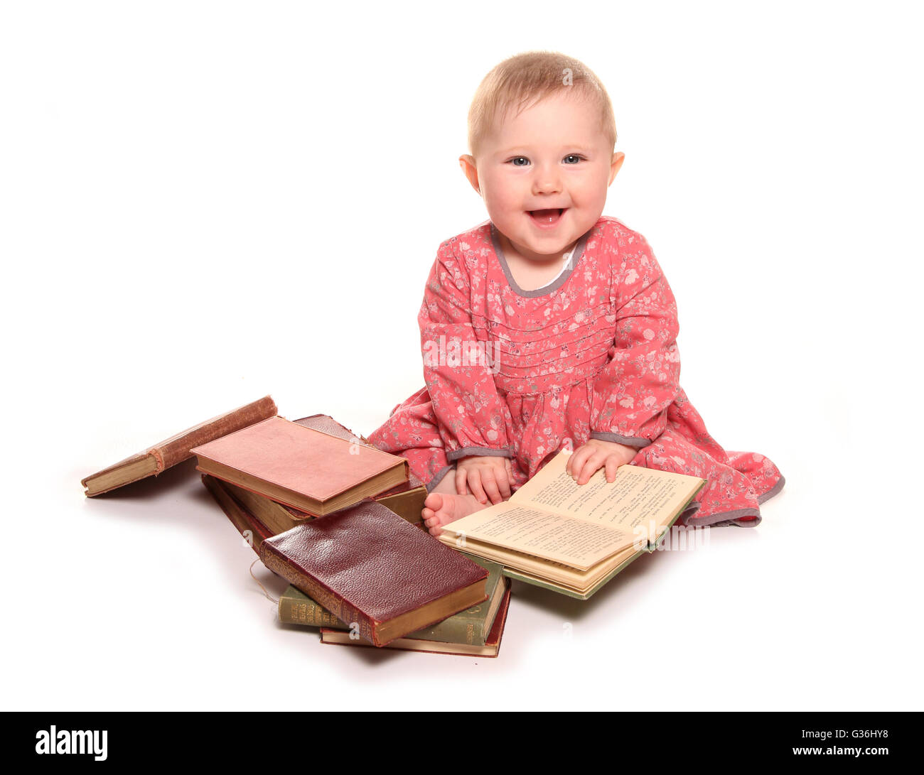 Baby girl reading some books cutout Stock Photo - Alamy