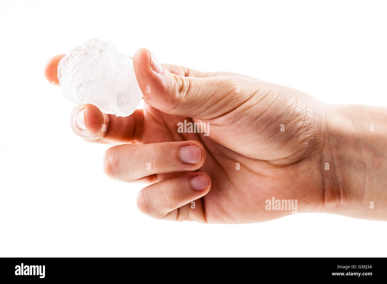 a male hand holding a fragment of quartz mineral isolated on a white ...