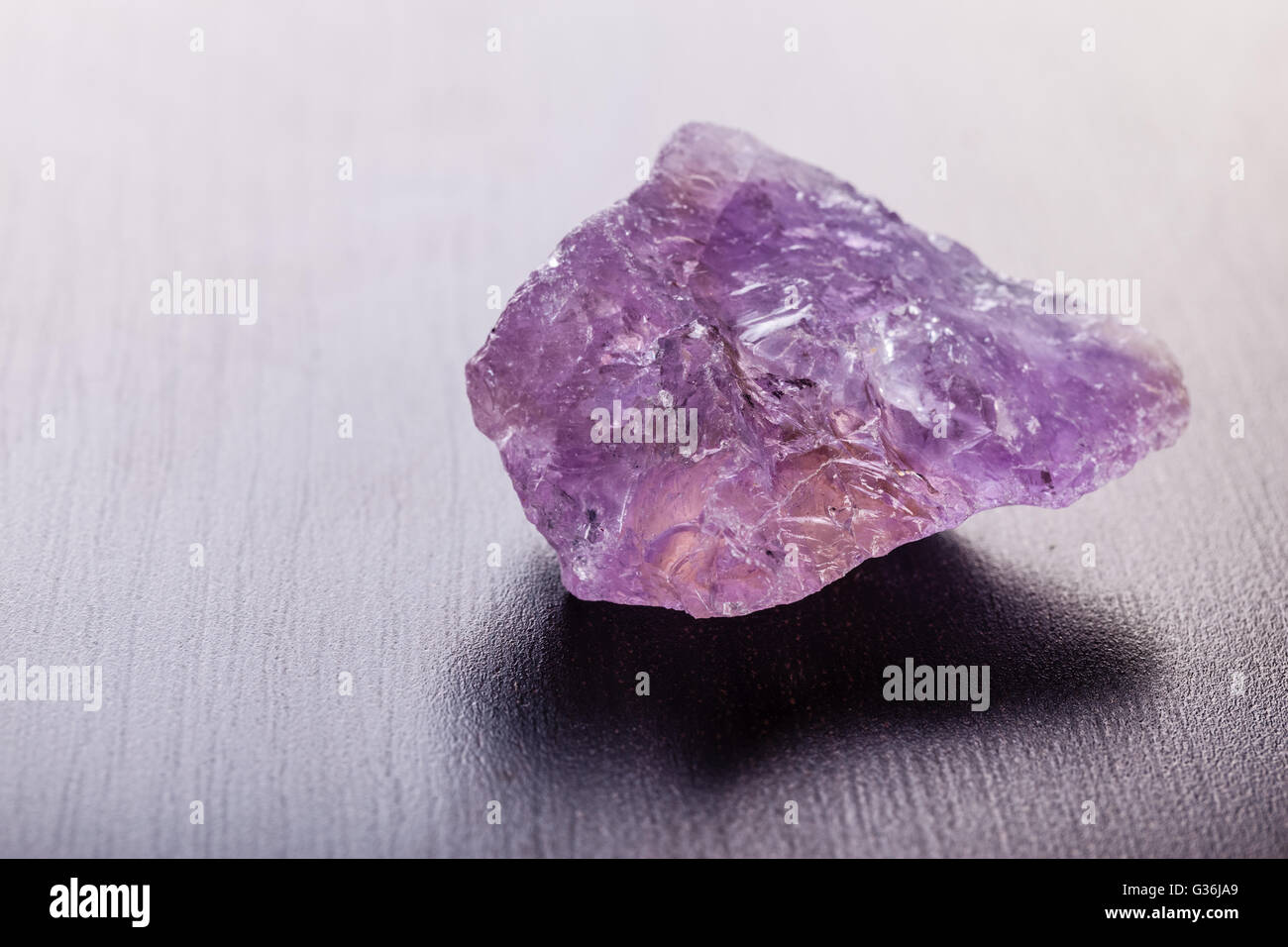 close up shot of a fragment of amethyst mineral on a dark surface Stock ...