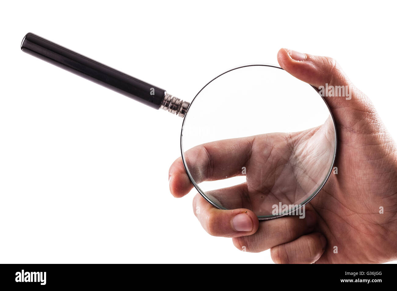 a male hand holding a magnifiyng glass isolated over a white background ...