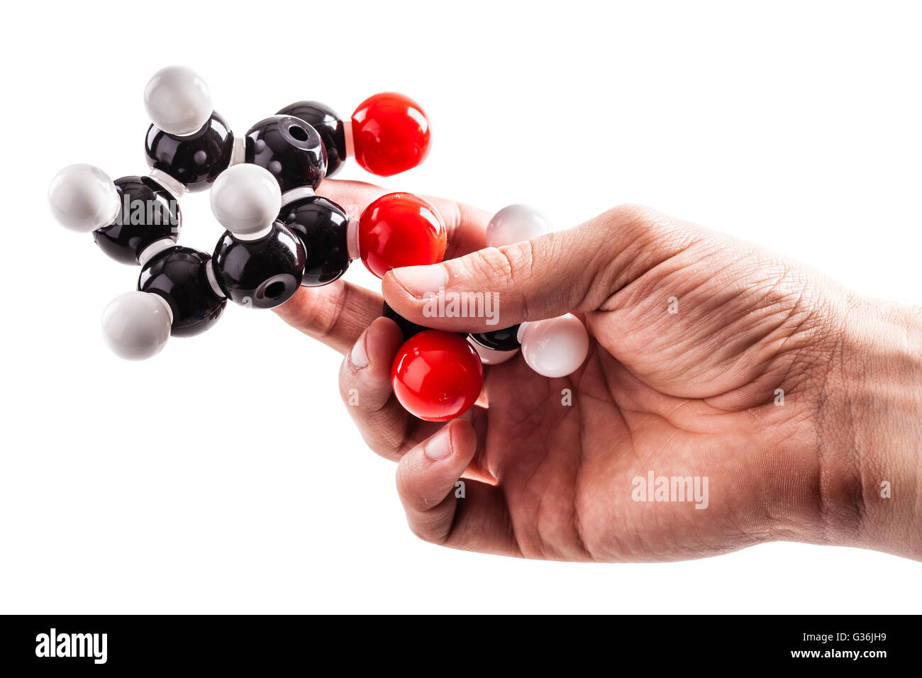 a male hand holding a molecule chemical structure model isolated over a ...
