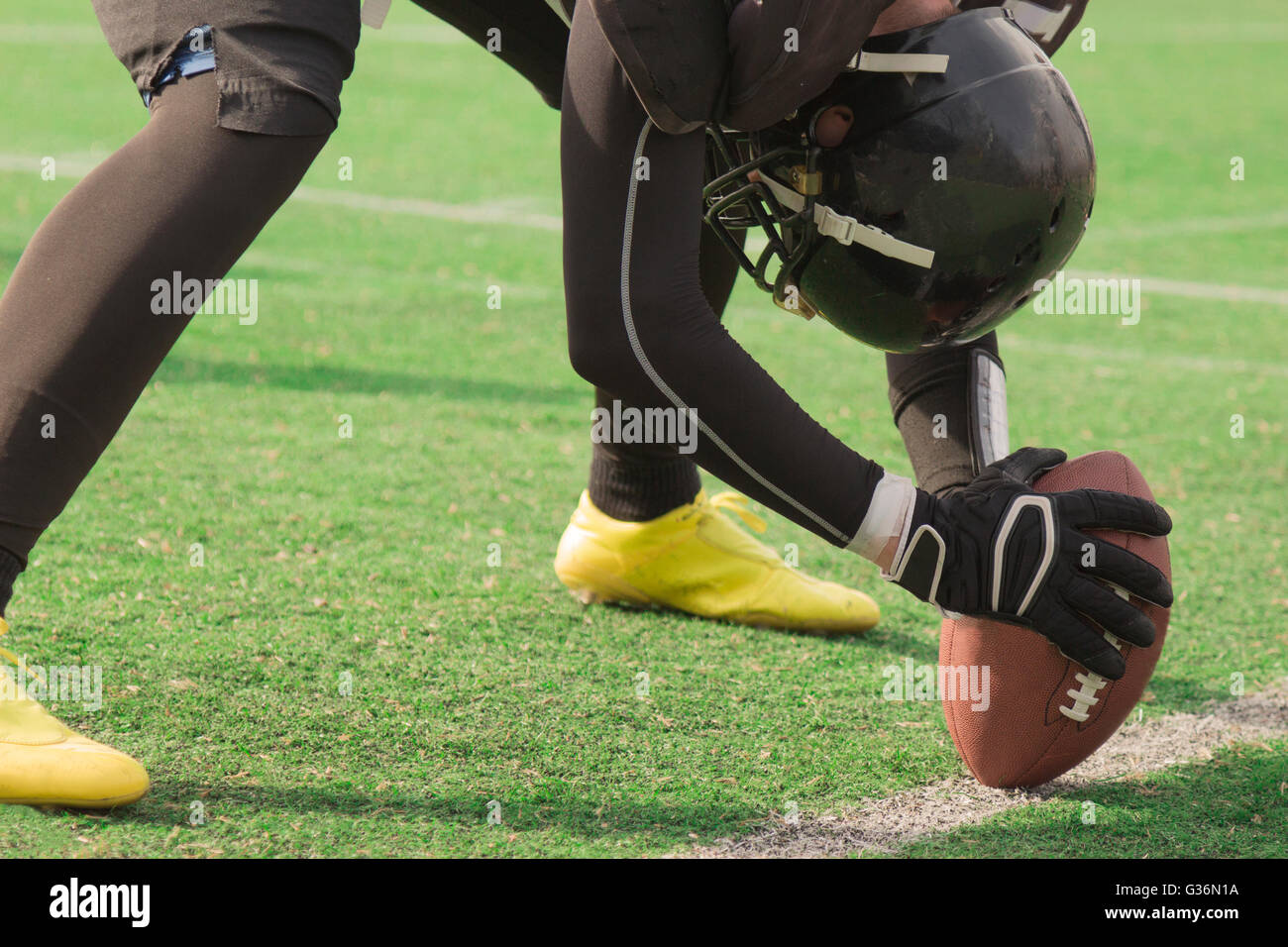 American football player setting up to snap the ball Stock Photo - Alamy