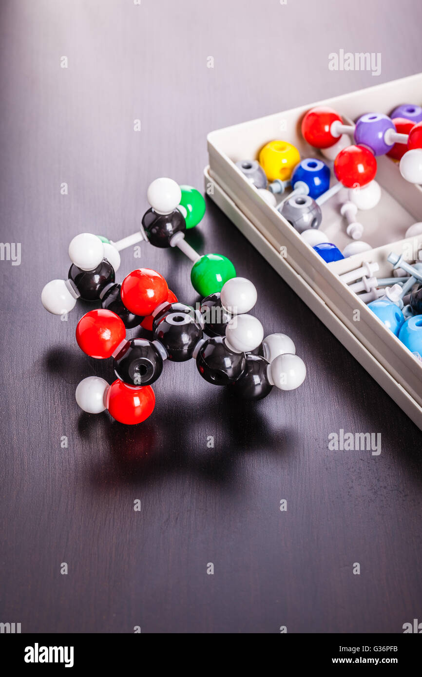 a plastic molecule structure modeling kit on a wooden surface Stock ...