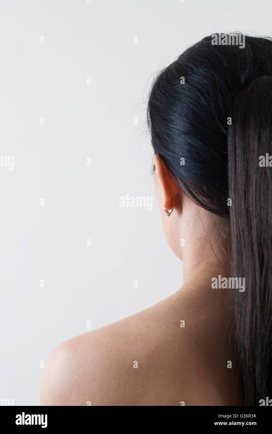 Rear view of a young woman with bare shoulder Stock Photo - Alamy