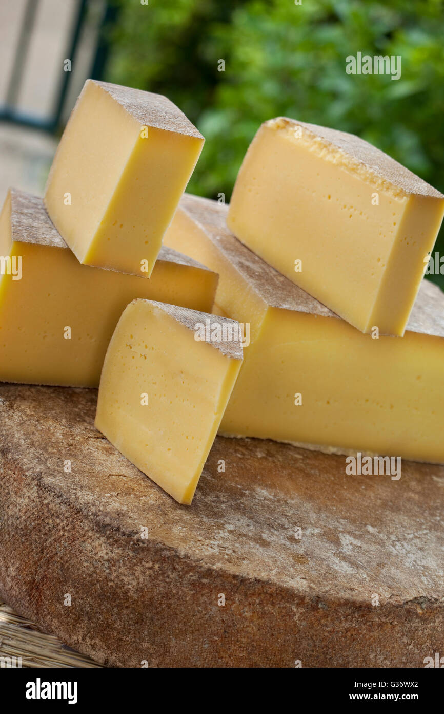 Sheep cheese on a table on a market stall Stock Photo - Alamy