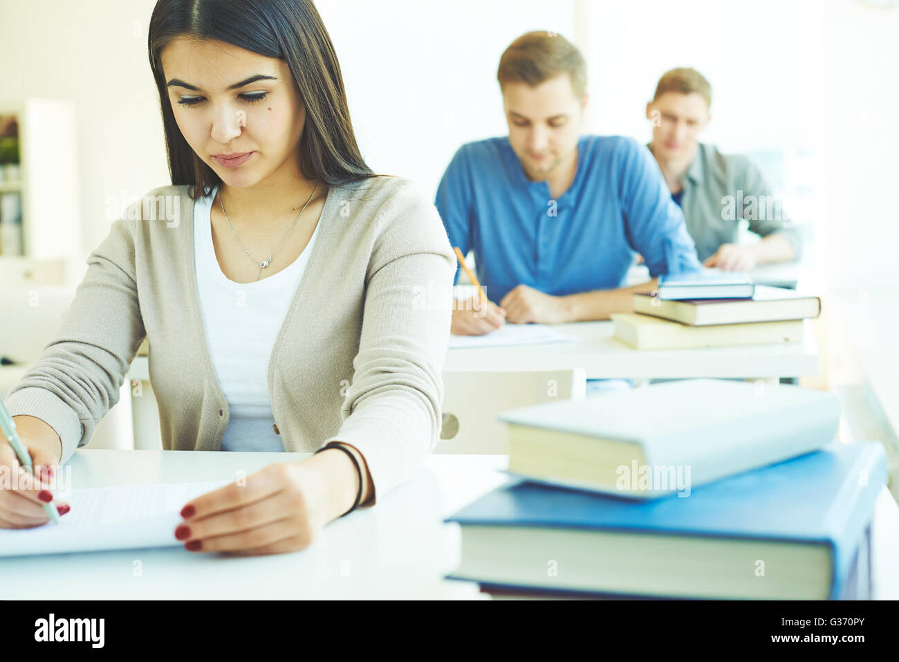 Teenager reading book desk hi-res stock photography and images - Alamy