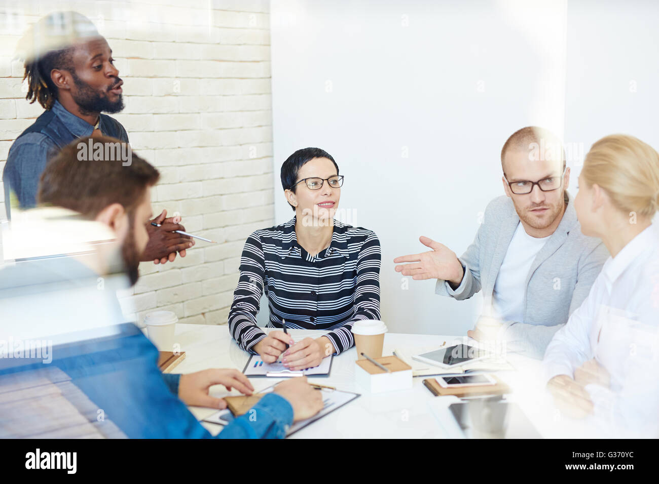 Meeting multi ethnic managers planning hi-res stock photography and ...