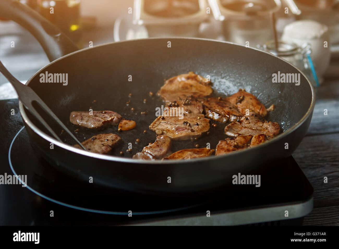 Pieces of meat on pan Stock Photo - Alamy