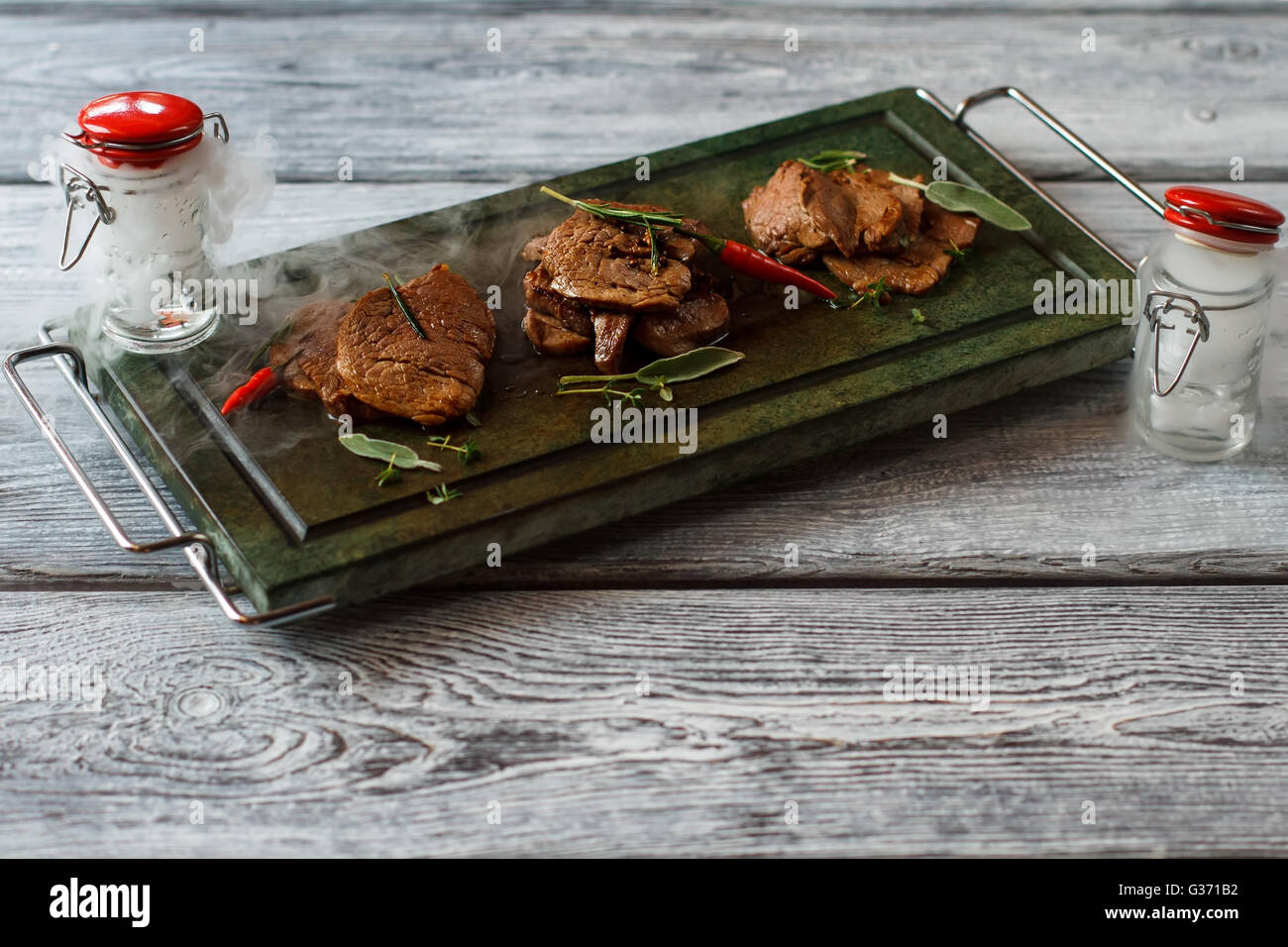 Tray with cooked meat Stock Photo - Alamy