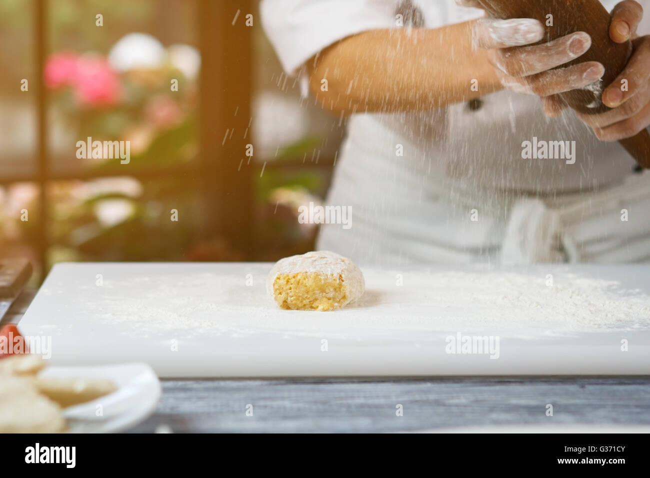 Flour falling onto dough Stock Photo - Alamy