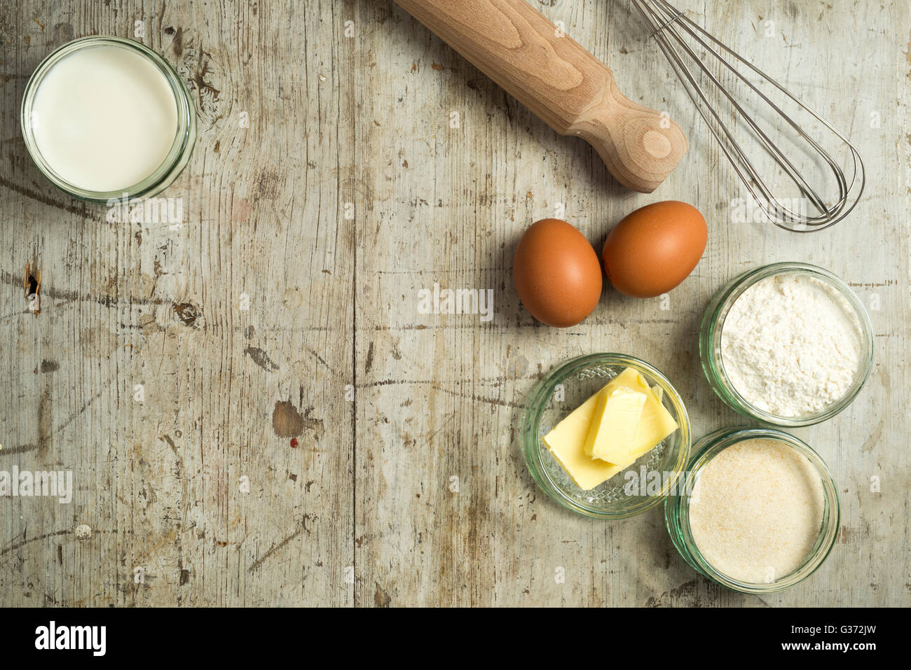 Pastry ingredients and baking equipment on wooden counter Stock Photo ...