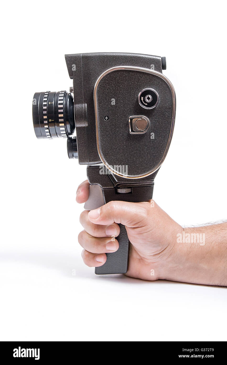 Old movie camera with lens in hand isolated on a white background Stock ...