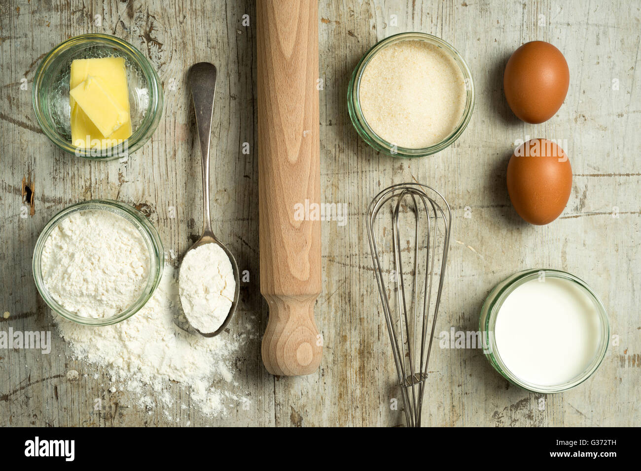 Baking ingredients laid flat on a wooden counter Stock Photo - Alamy