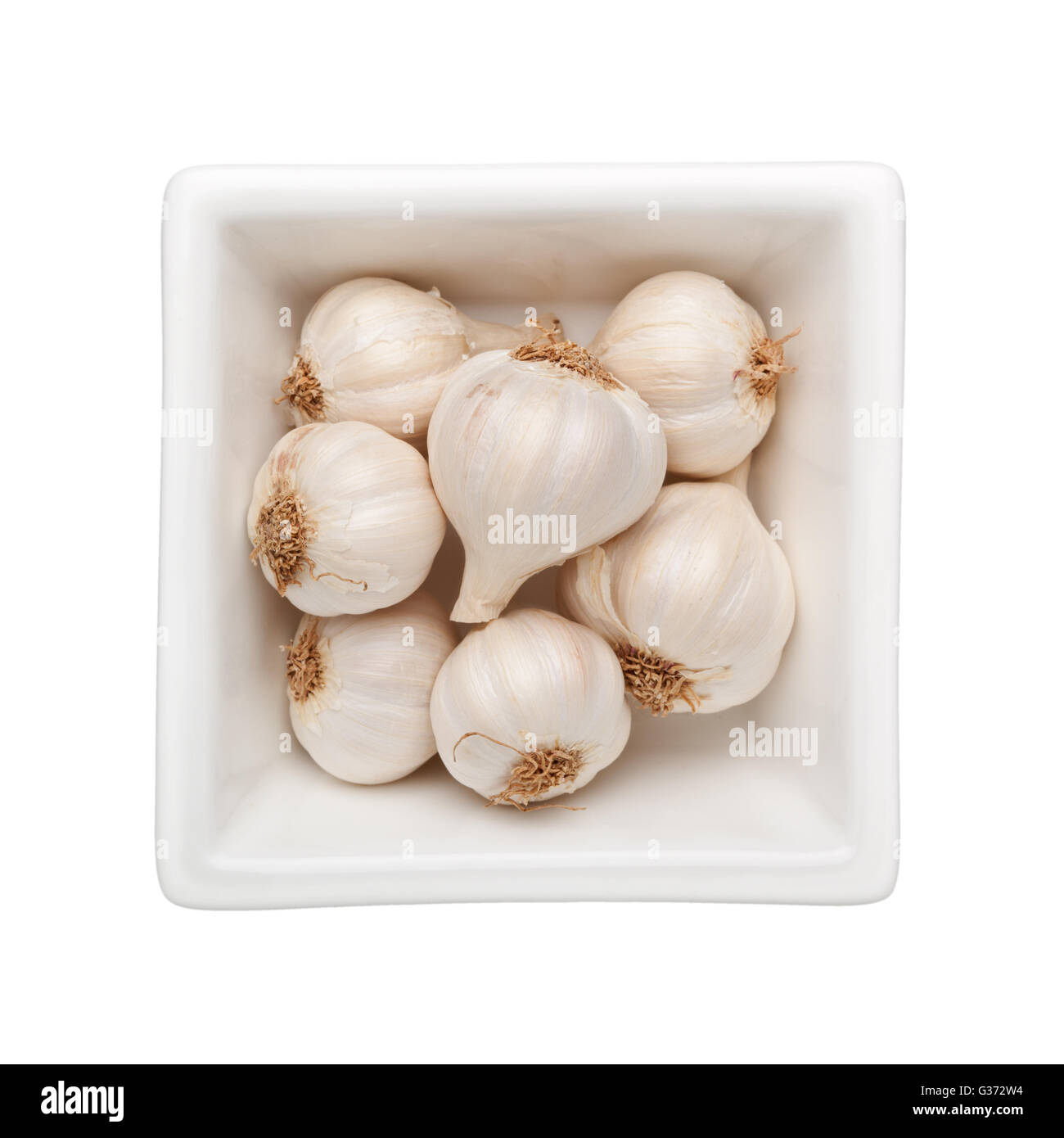 Cloves of garlic in a square bowl isolated on white background Stock ...