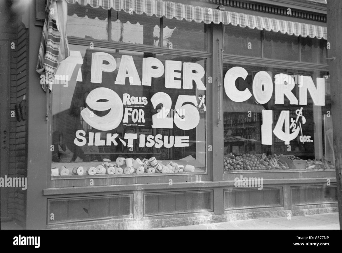 A sign in grocery store window PAPER - 9 rolls for 25 cents Stock Photo ...