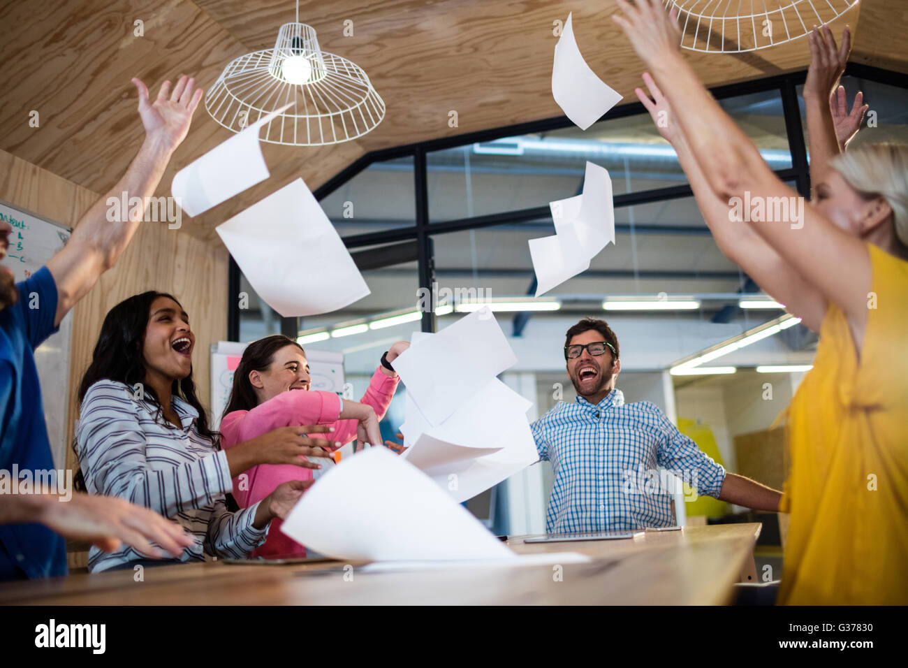 Casual colleagues throwing paper Stock Photo - Alamy