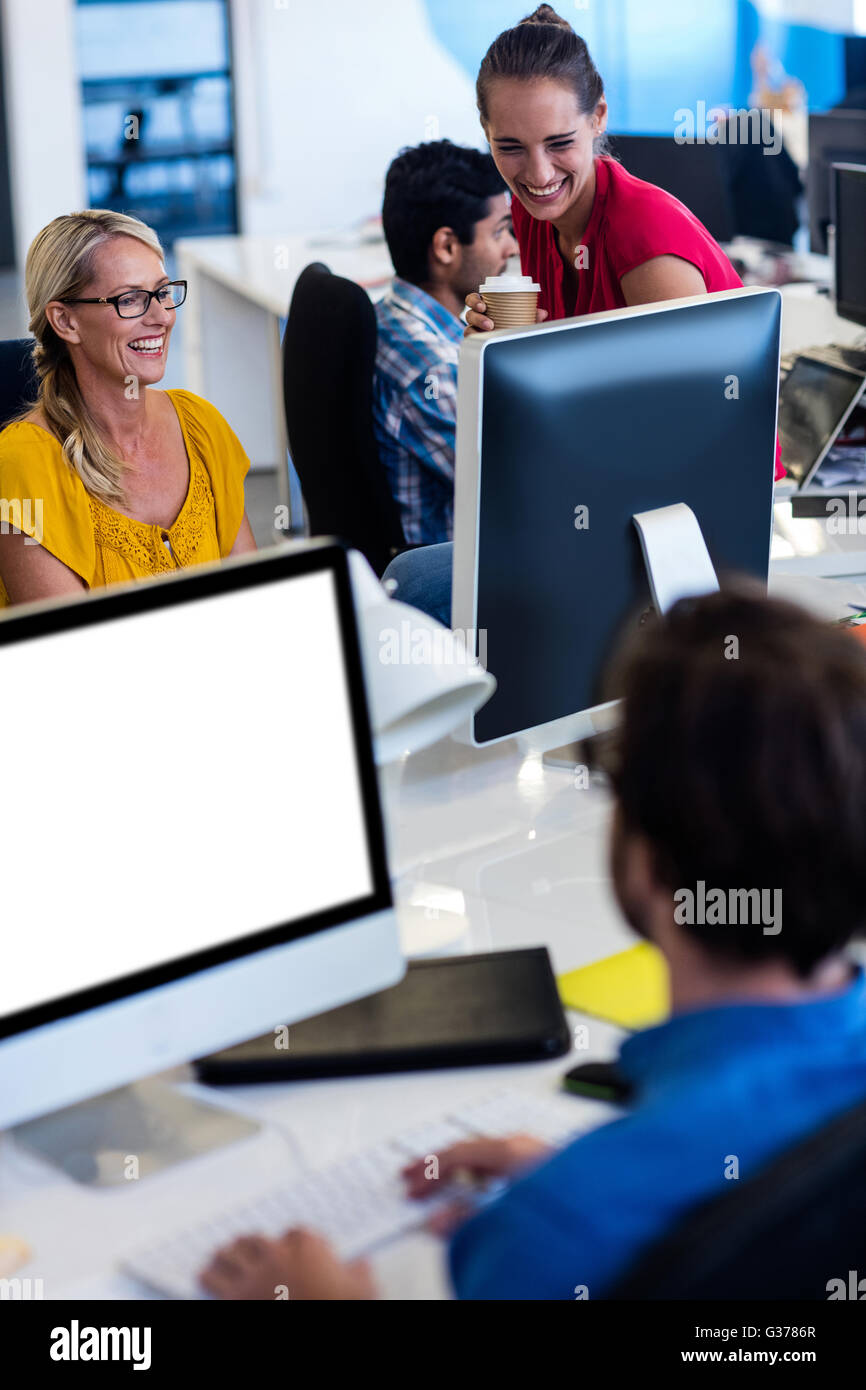 Casual colleagues using computer Stock Photo - Alamy