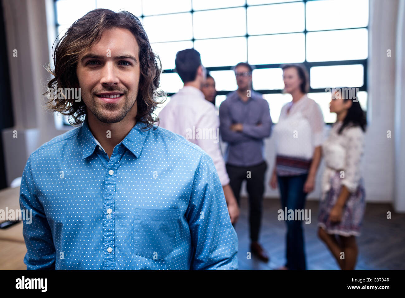 Portrait of a hipster and group of coworkers Stock Photo - Alamy
