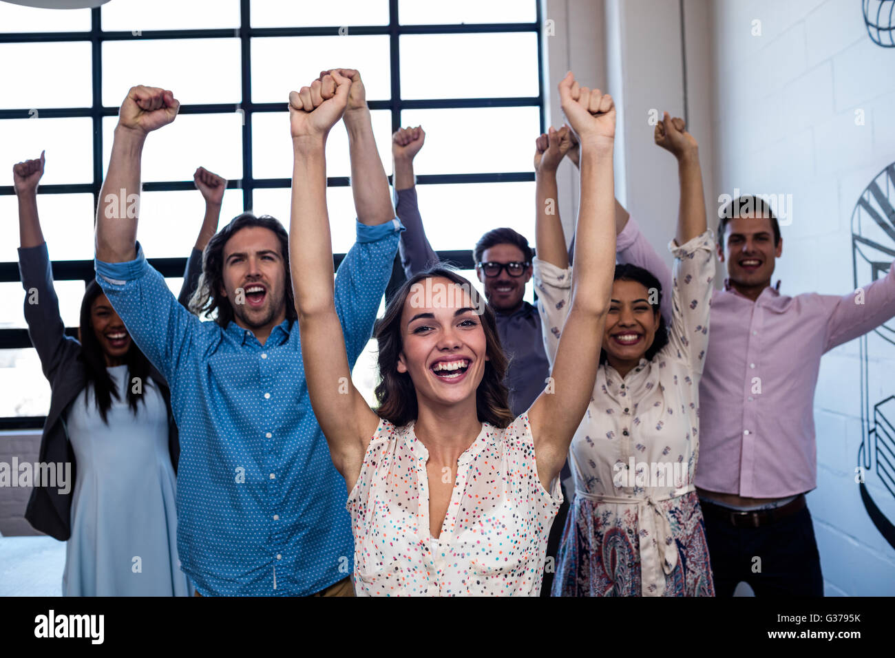 Group of coworkers hands up Stock Photo - Alamy