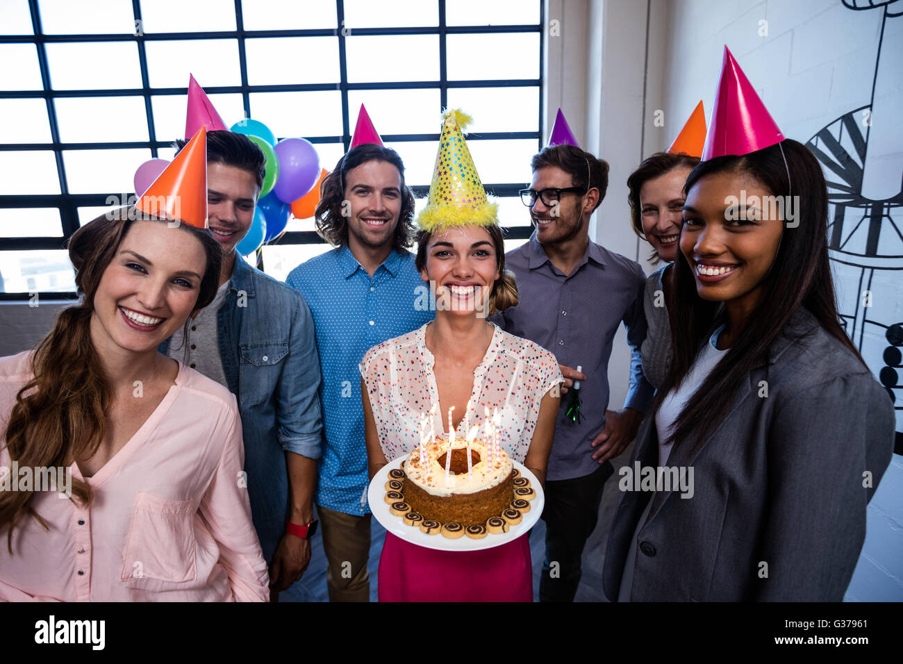 Happy coworkers celebrating a birthday Stock Photo - Alamy