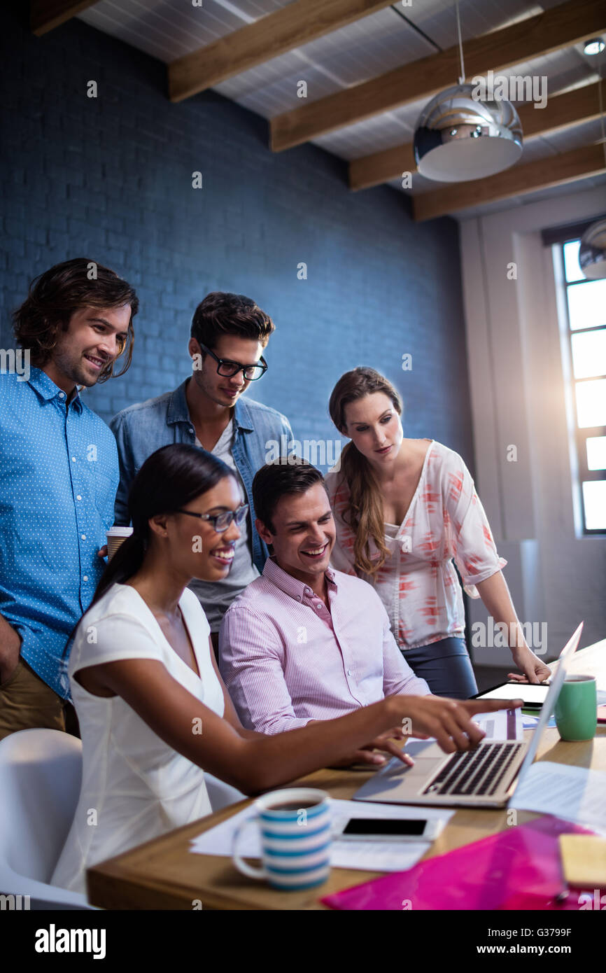 Group of coworkers watching a laptop Stock Photo - Alamy