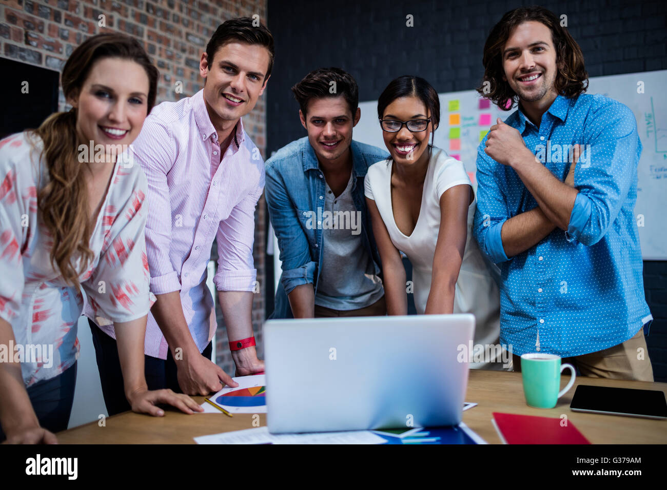 Group of designers working on a computer Stock Photo - Alamy