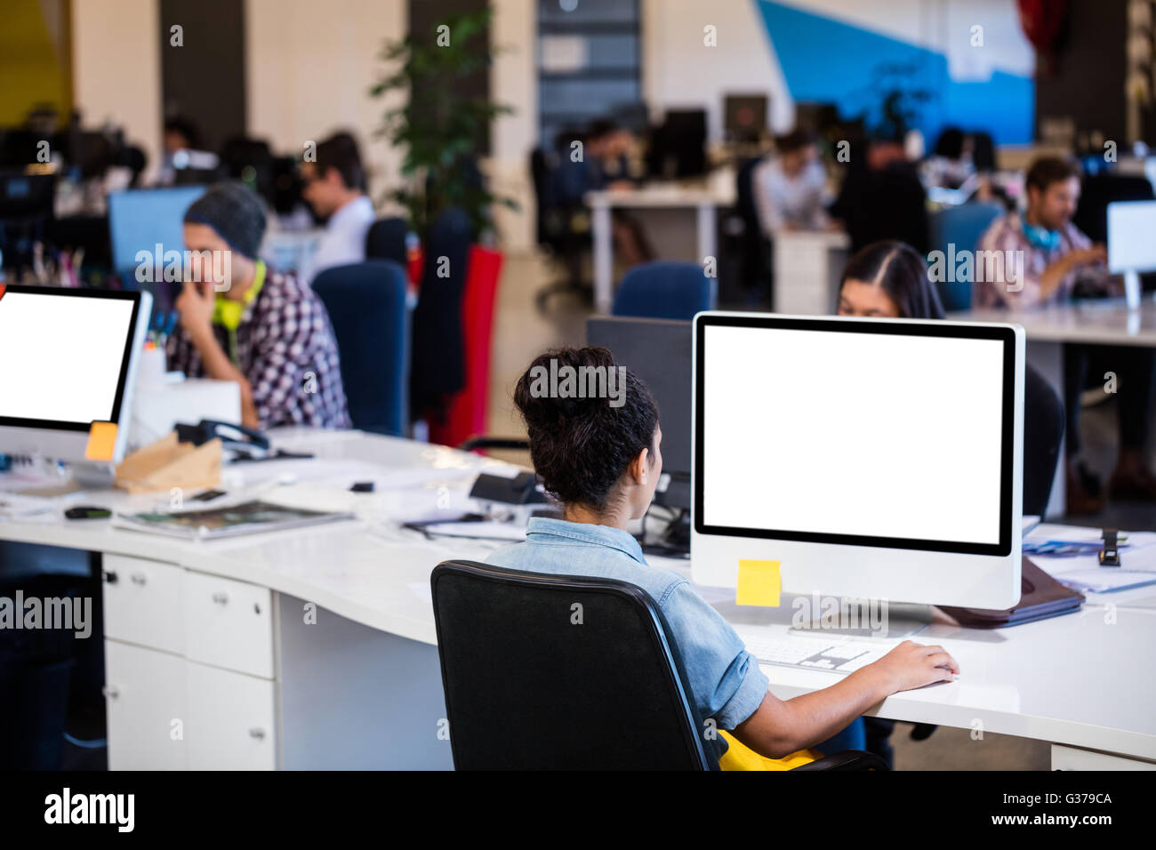Focus on foreground of business people working Stock Photo - Alamy