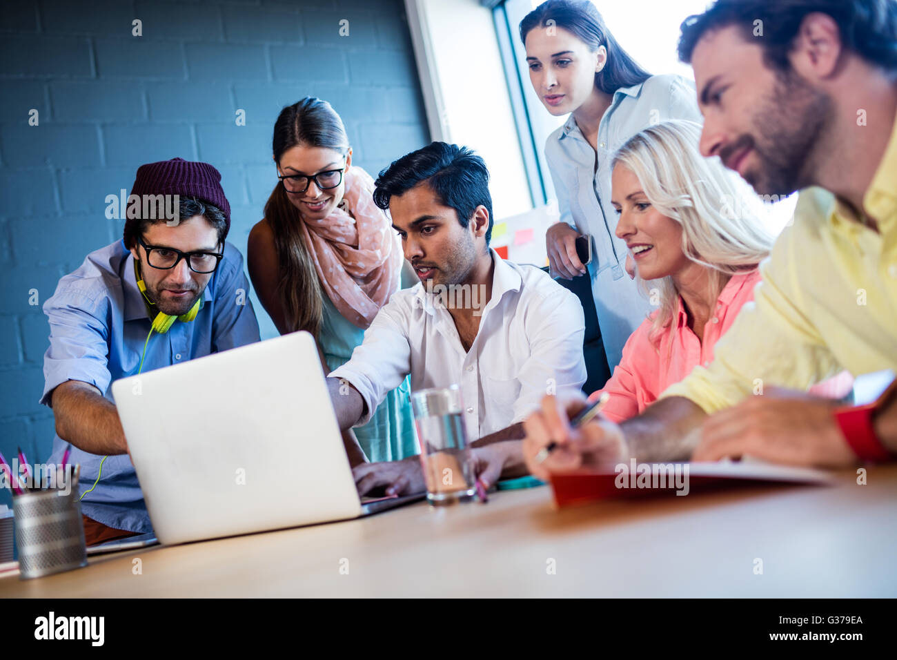 Group of coworkers using a laptop Stock Photo - Alamy