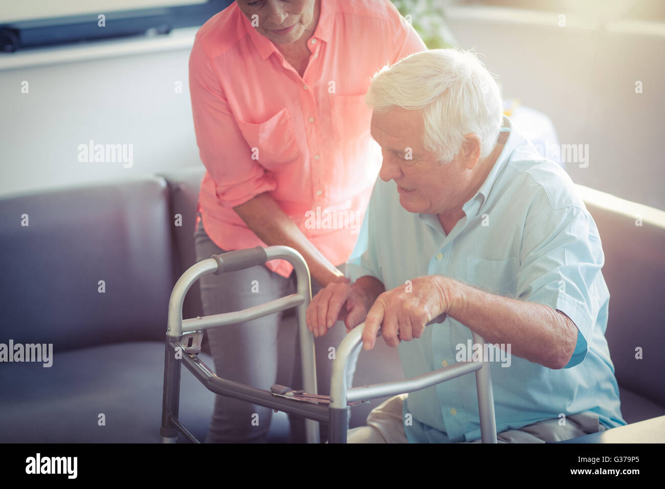 Senior woman helping man walk hi-res stock photography and images - Alamy