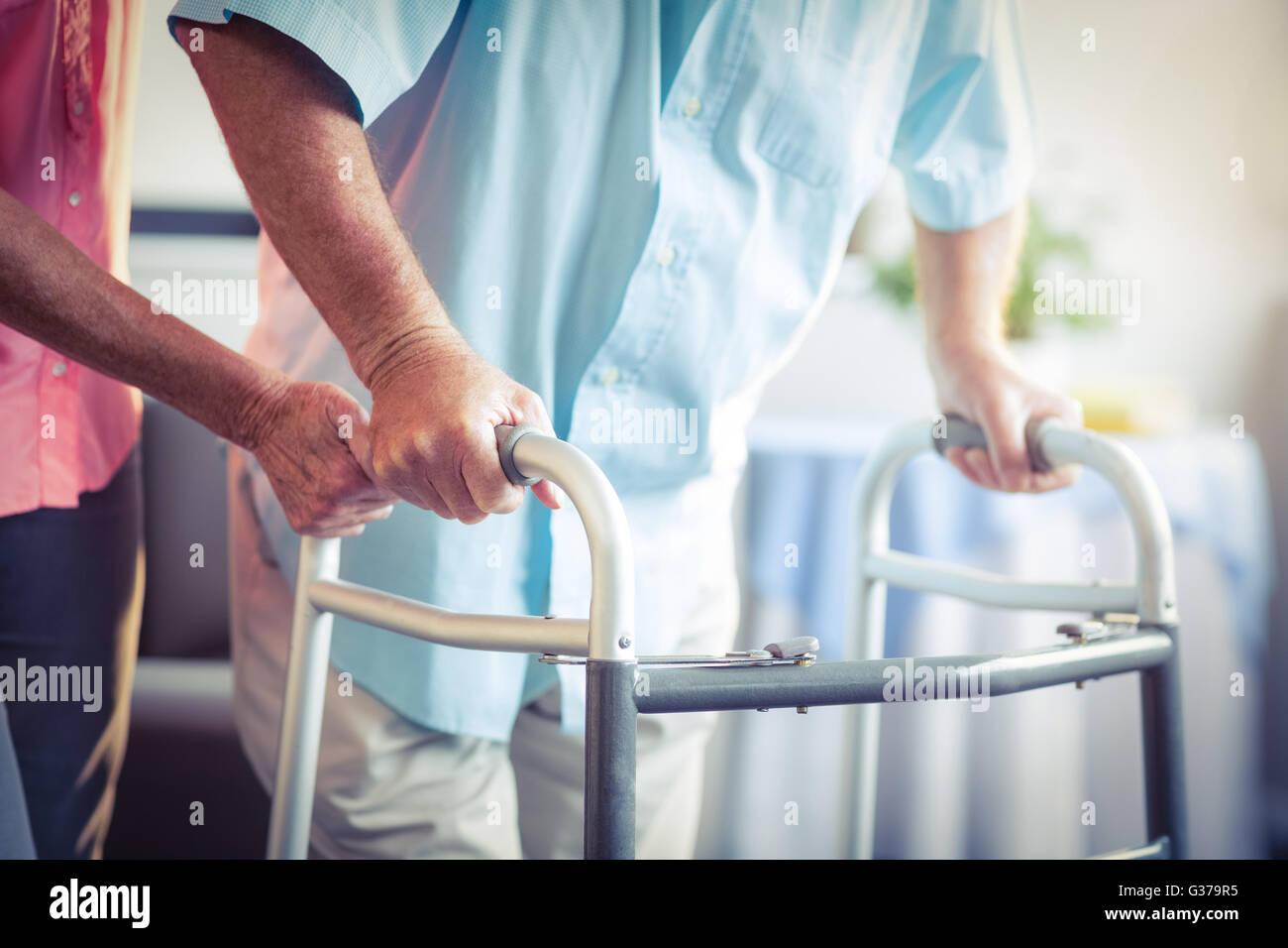 Senior woman helping man walk hi-res stock photography and images - Alamy