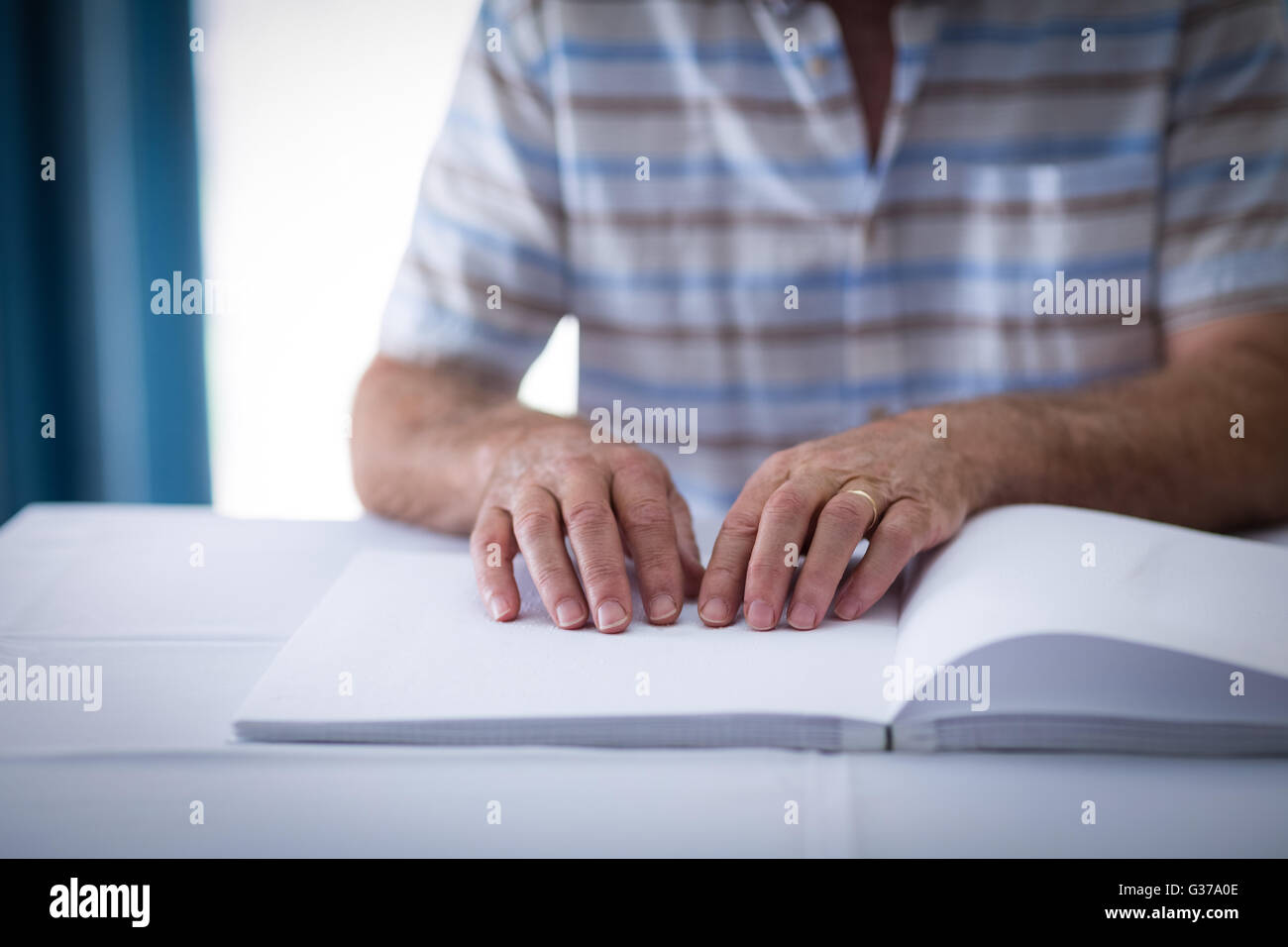 Blind man reading a braille book Stock Photo - Alamy