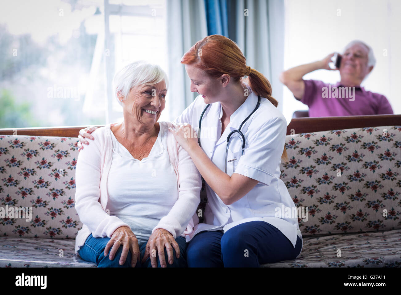 Elderly woman doctor sitting hi-res stock photography and images - Alamy