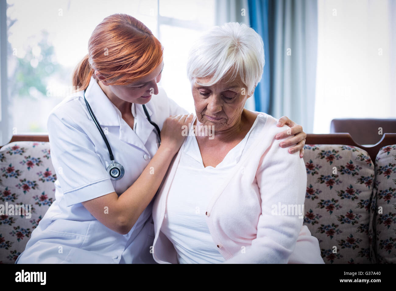 Doctor comforting woman hi-res stock photography and images - Alamy