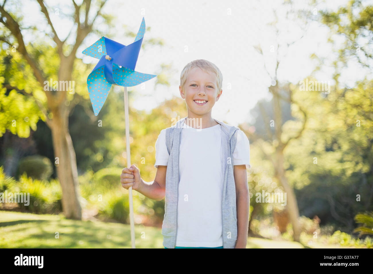 Boy holding a pinwheel in park Stock Photo - Alamy