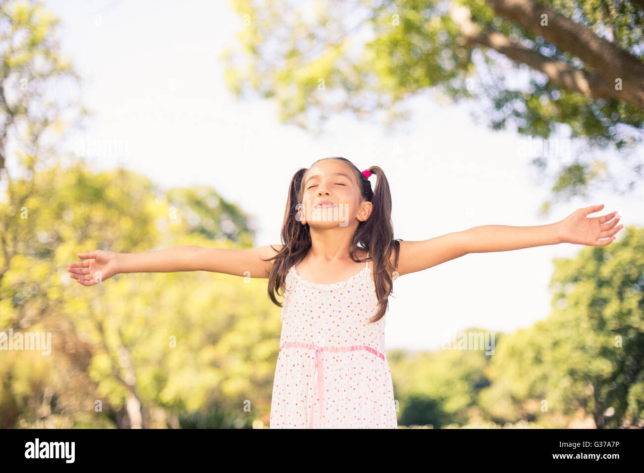 Young girl with arms outstretched Stock Photo - Alamy