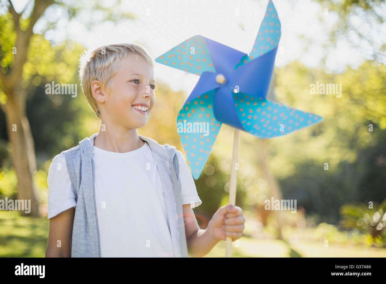 Boy holding a pinwheel in park Stock Photo - Alamy