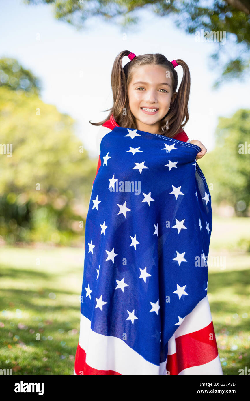 Young girl wrapped in American flag Stock Photo - Alamy