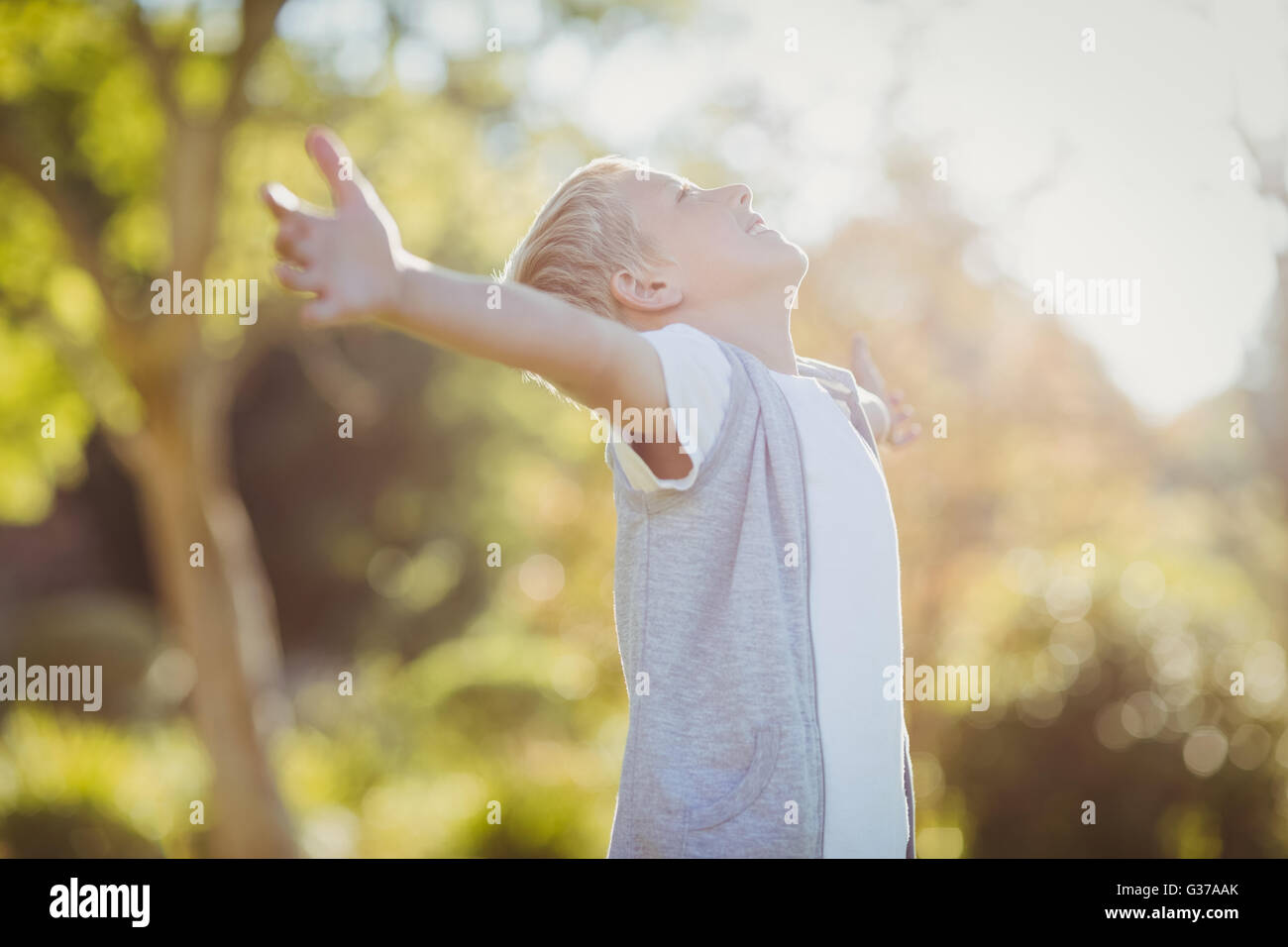 Young boy with arms outstretched Stock Photo - Alamy
