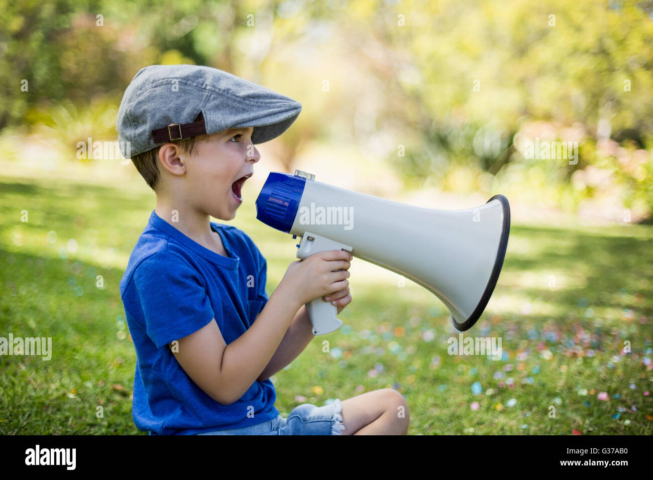 Young boy speaking on megaphone Stock Photo - Alamy