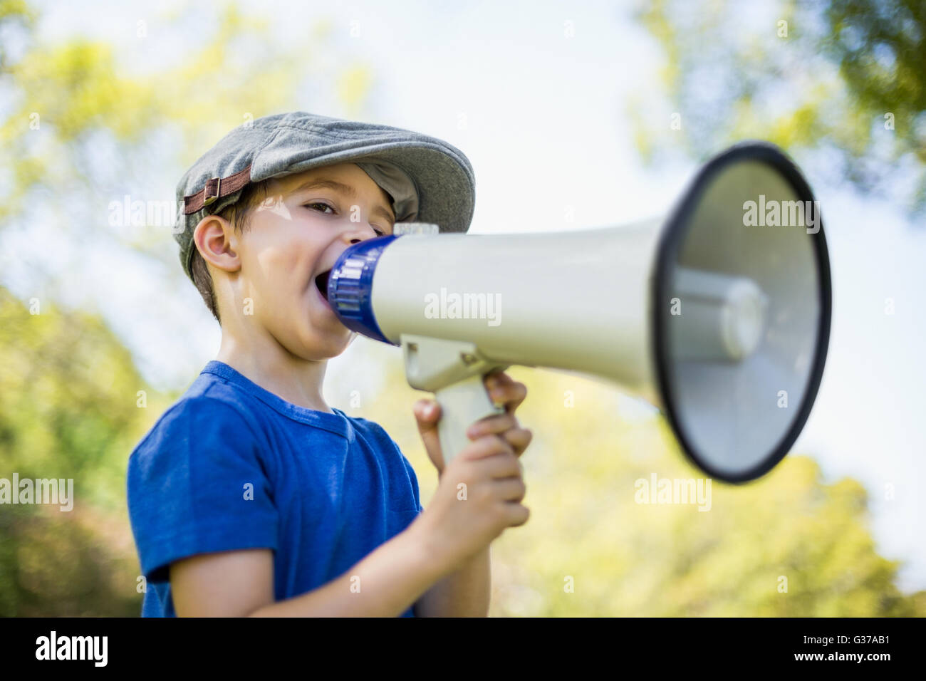 Young boy speaking on megaphone Stock Photo - Alamy