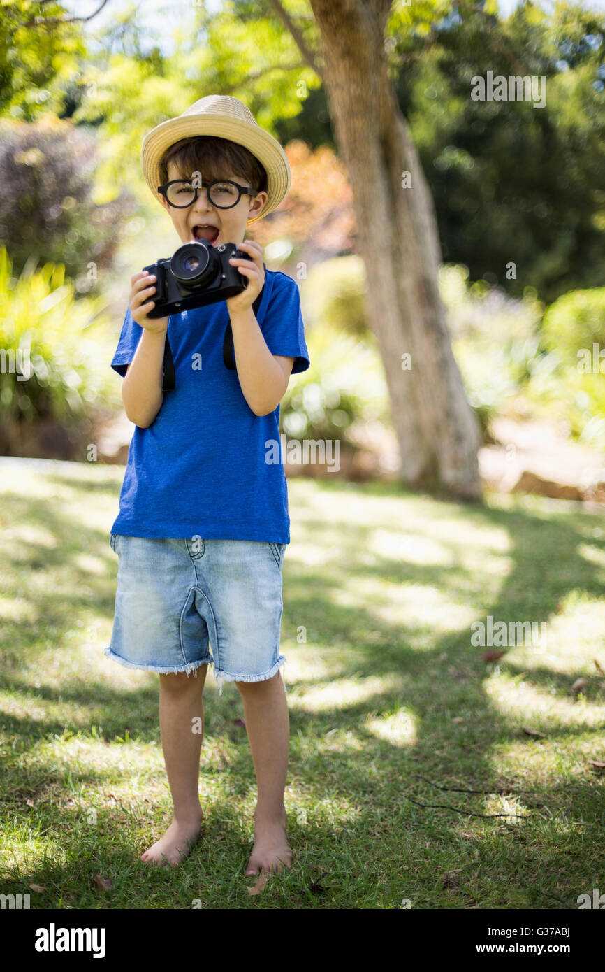 Young boy in spectacles holding a camera Stock Photo - Alamy