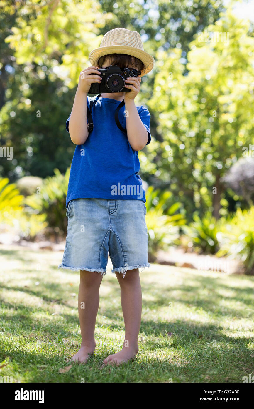 Young boy clicking a photograph from camera Stock Photo - Alamy