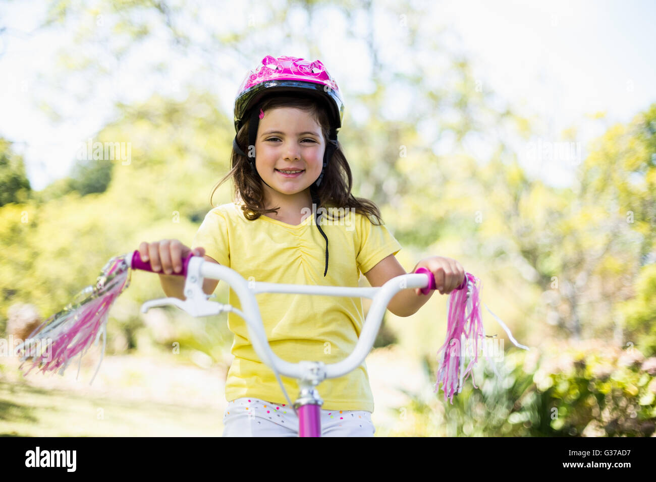 Smiling girl riding a bicycle Stock Photo - Alamy