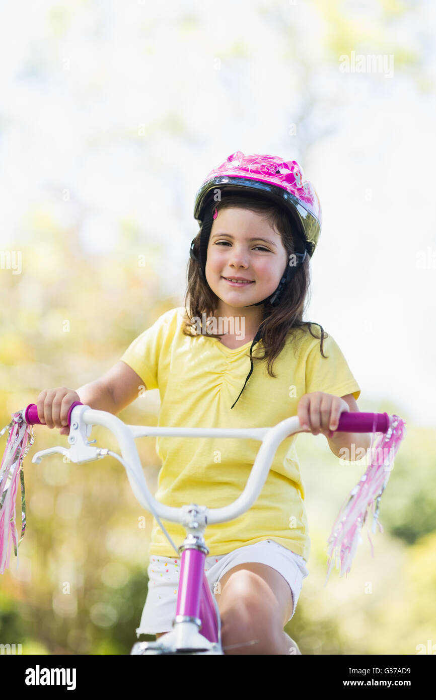 Smiling girl riding a bicycle Stock Photo - Alamy