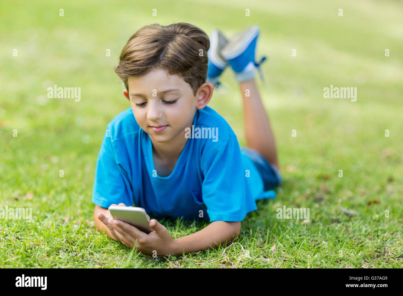 Young boy using mobile phone Stock Photo - Alamy