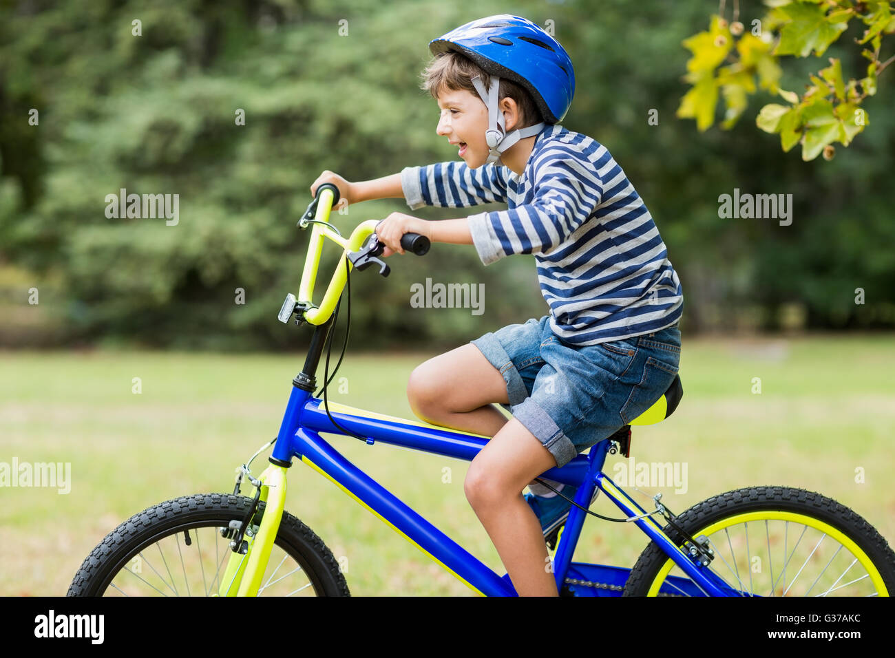 Smiling boy riding a bicycle Stock Photo - Alamy