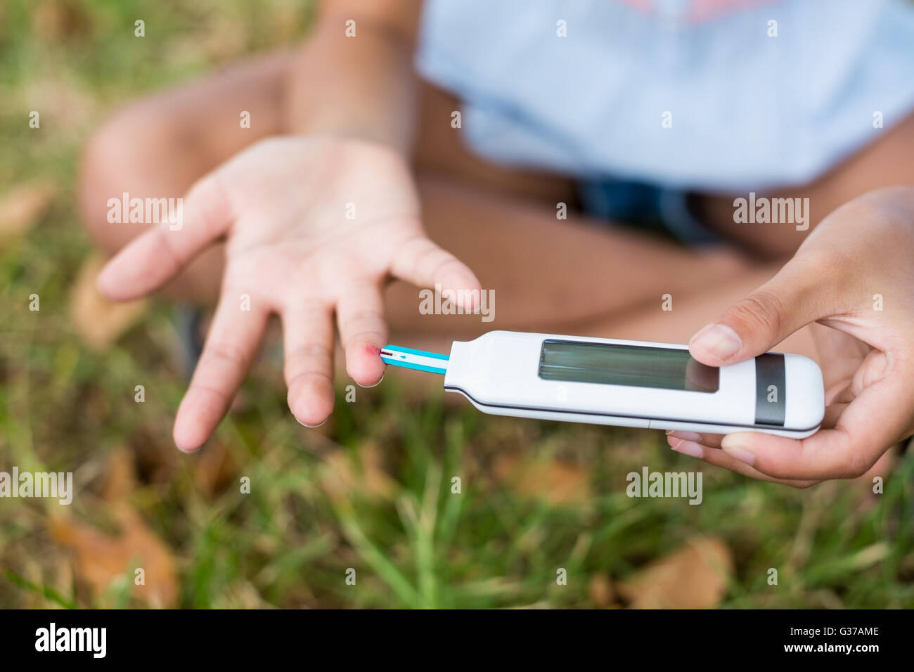 Child with blood glucose meter hi-res stock photography and images - Alamy