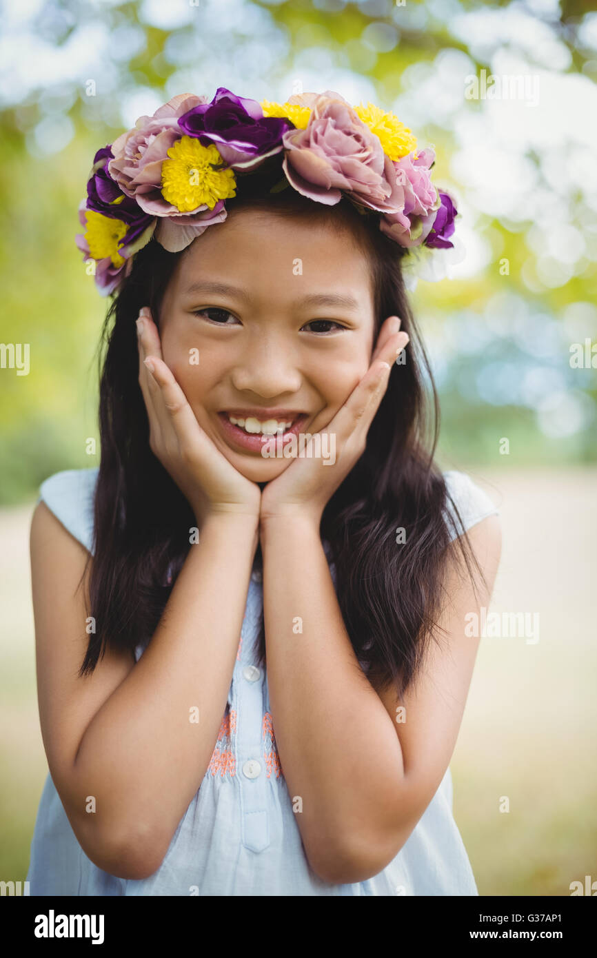 Portrait of smiling girl posing in park Stock Photo - Alamy